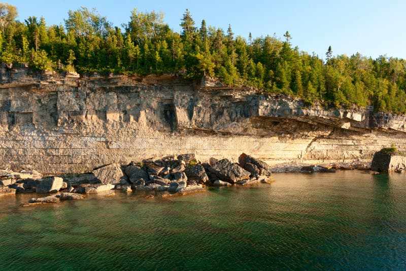Woody Cliffs at Lakeshore stock image. Image of water - 68807479