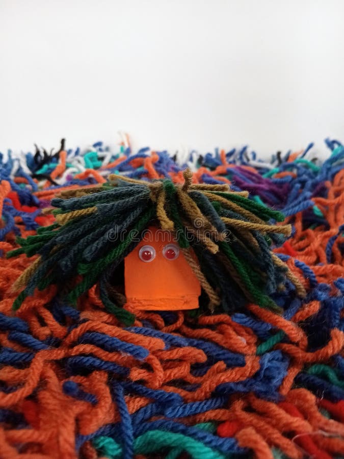 Wool Character with Googly Eyes and Yarn Hair on a White and Yarn ...