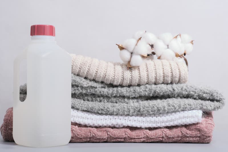 Wool Detergent in a Bottle and Stack of Pullovers with Cotton Buds ...