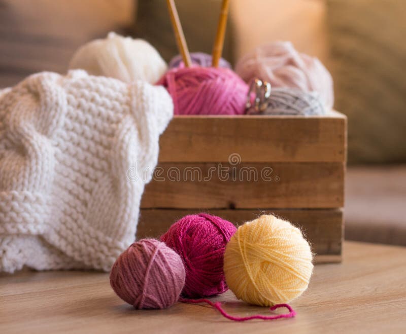 Woolen Balls in Front of a Wooden Box with Wool and Bamboo Knitting ...