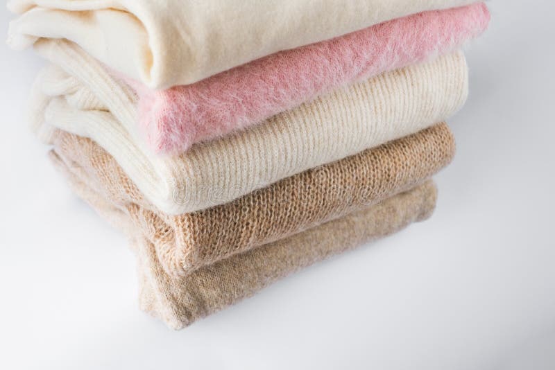 Woolen Clothes of Light Shades, Folded on a White Background Stock ...