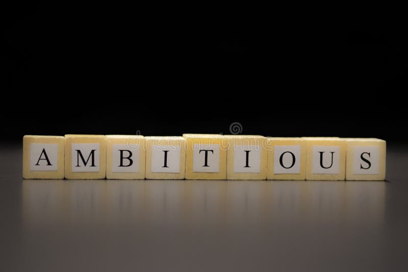 The Word AMBITIOUS Written on Wooden Cubes, Isolated on a Black ...