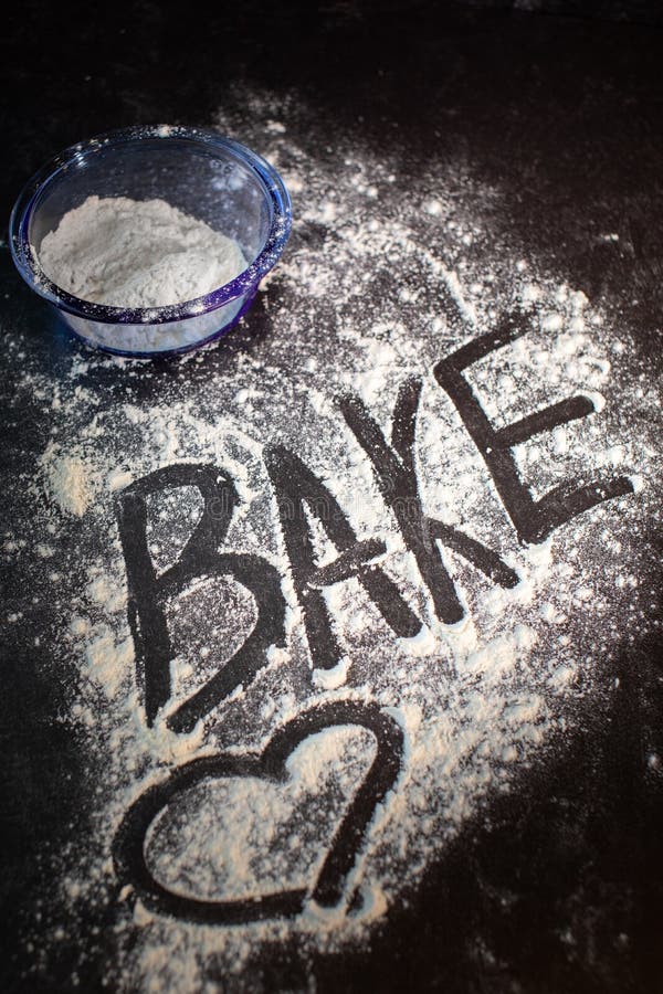 The Word Bake with a Heart in Flour Dusted on Table Stock Image - Image ...