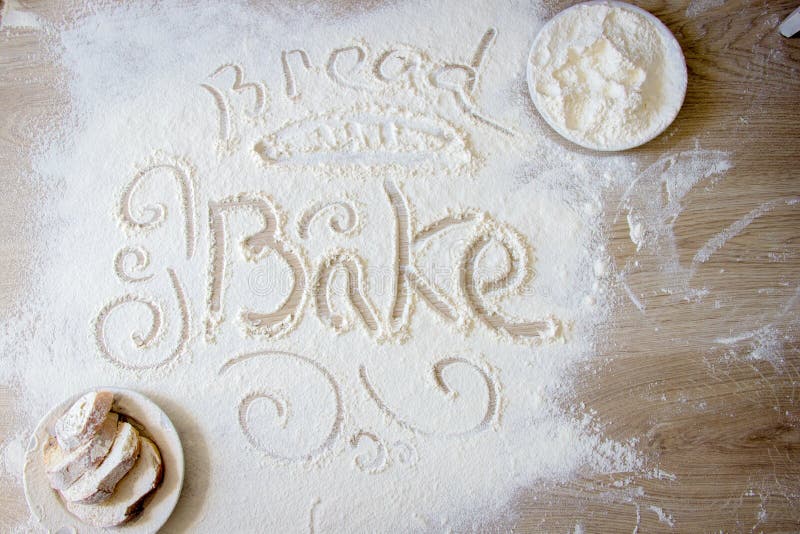 The Word Bakery Hand Written in Flour on a Wood Table. Stock Photo ...