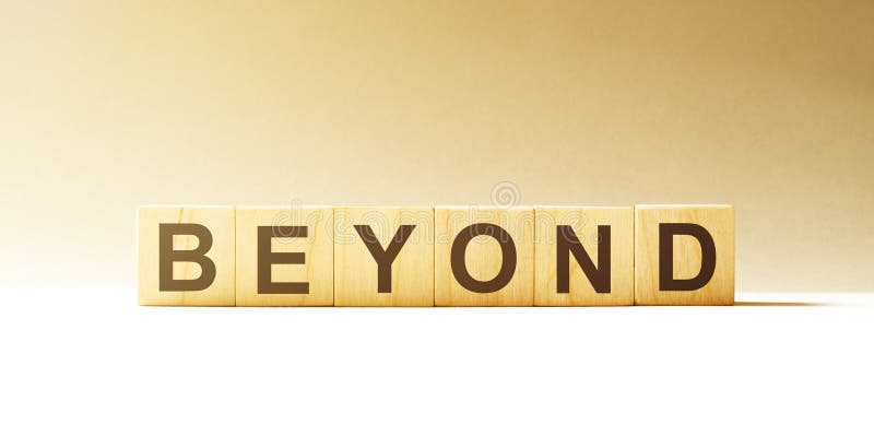 BEYOND Word Written on Wood Block. BEYOND Text on Wooden Table for Your ...
