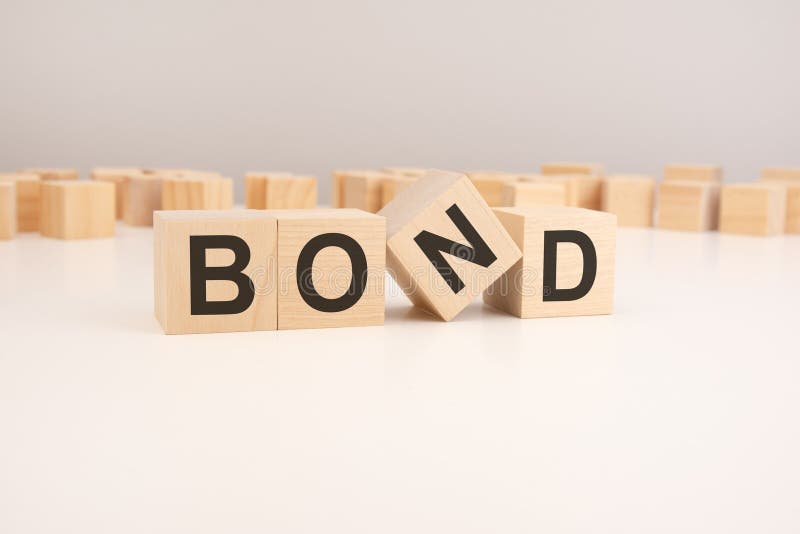The Word Bond Written on Wooden Dice Lying on a Table Stock Image ...