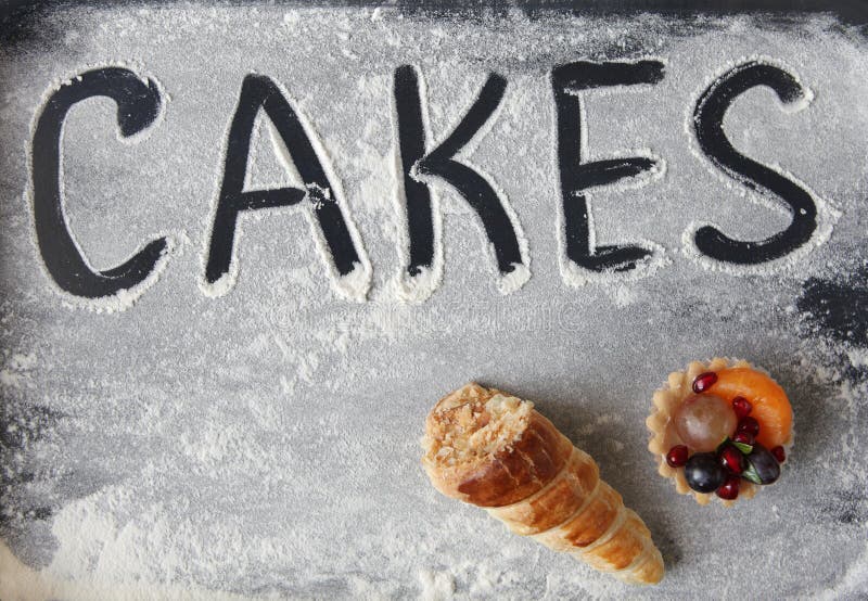 Word CAKES on the Flour, Together with Small Cakes Stock Image - Image ...