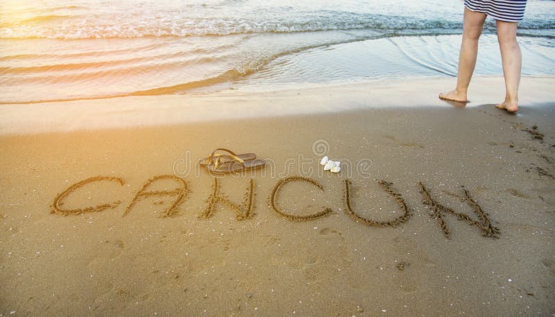 The Word Cancun Written in the Sand on Beach. Vacation Concept. Stock ...