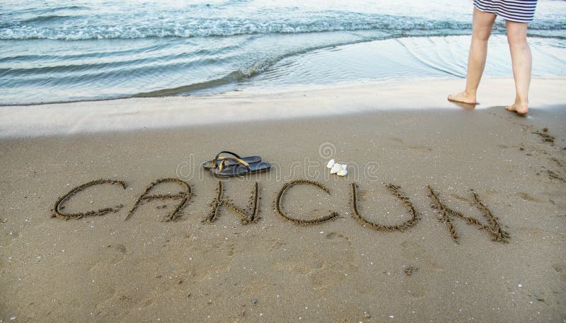 The Word Cancun Written in the Sand on Beach. Vacation Concept. Stock ...