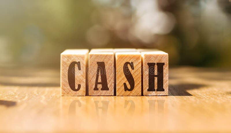 Word CASH Made with Building Wooden Blocks on Table in Sunlight Stock ...