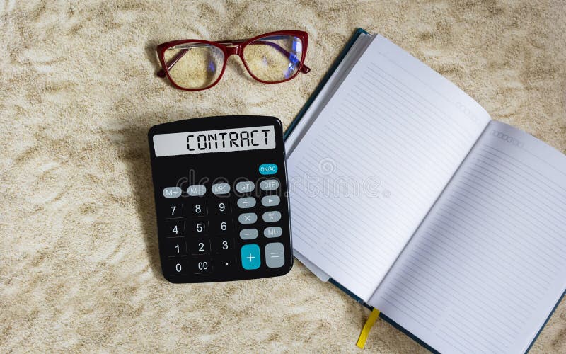 The Word Contract is Written on the Display of the Calculator, Next To ...