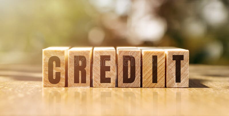 Word CREDIT Made with Building Wooden Blocks on Table in Sunlight Stock ...