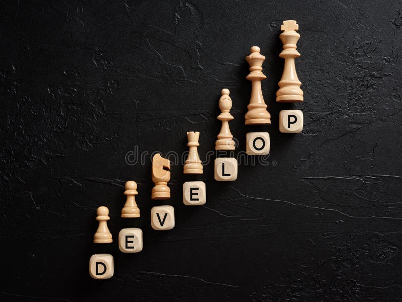 The Word Develop on Wooden Cubes with Chess Pieces Stock Image - Image ...
