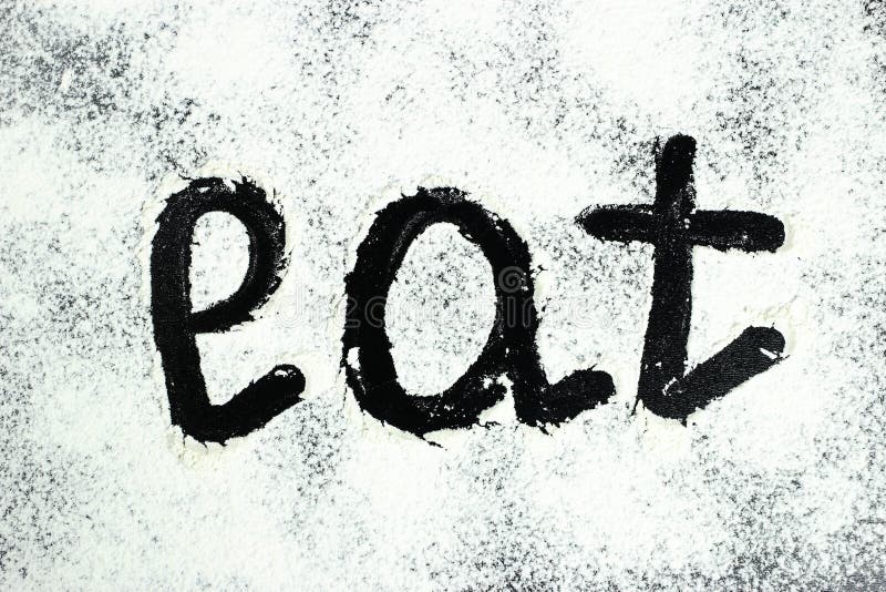 The Word Eat is Drawn with Finger on Flour, White Powder Stock Image ...