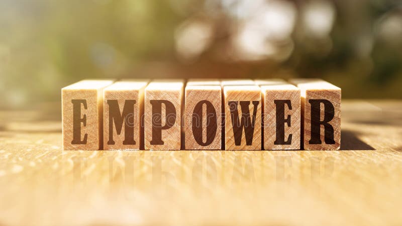 Word EMPOWER Made with Building Wooden Blocks on Table in Sunlight ...