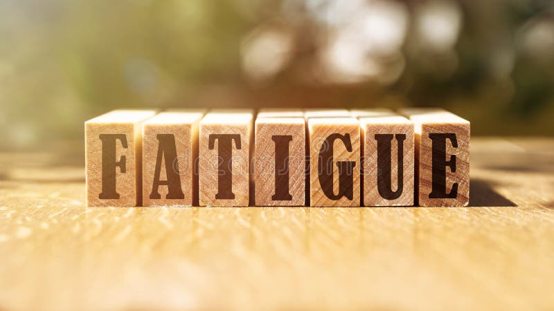 Word FATIGUE Made with Building Wooden Blocks on Table in Sunlight ...