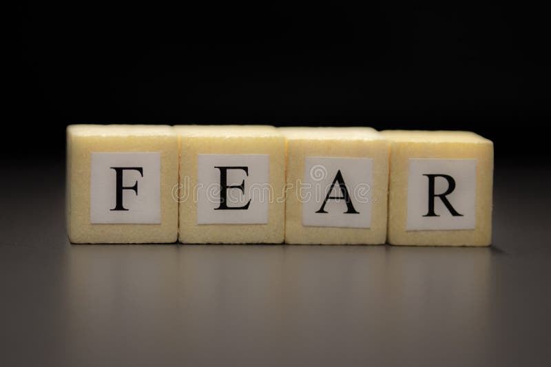 The Word FEAR Written on Wooden Cubes Isolated on a Black Background ... The Word FEAR Written on Wooden Cubes Isolated on a Black Background ...