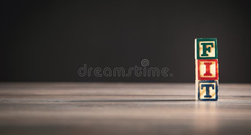 Word Fit on wooden cubes stock photo. Image of letter - 231312144