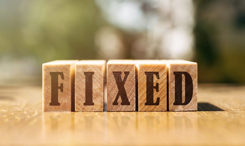 Word FIXED Made with Building Wooden Blocks on Table in Sunlight Stock ...