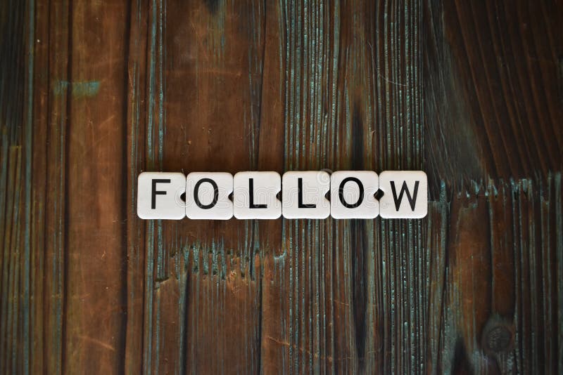 Word Follow Written with White Plastic Letters on a Wooden Surface ...