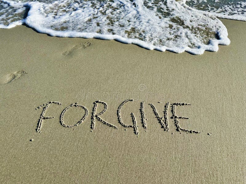 Word forgive in the sand stock image. Image of book - 259782085