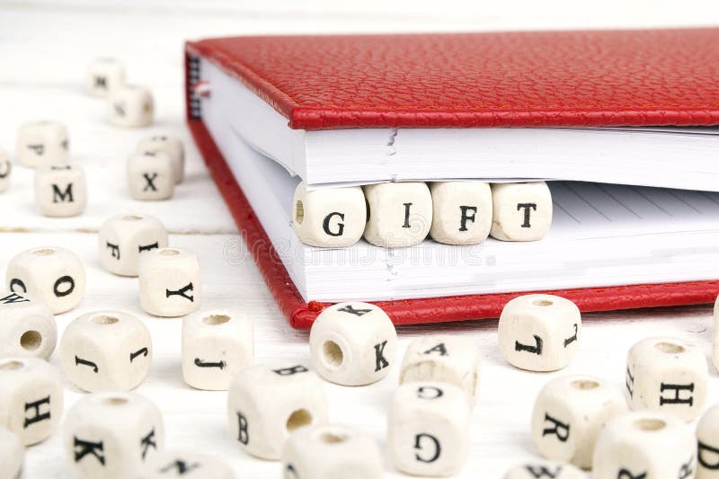 Word Gift Written in Wooden Blocks in Red Notebook on White Wood Stock ...