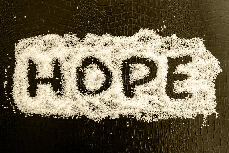 Spilled Salt and Salt Shaker on on a Black Stone Table, Selective Focus ...