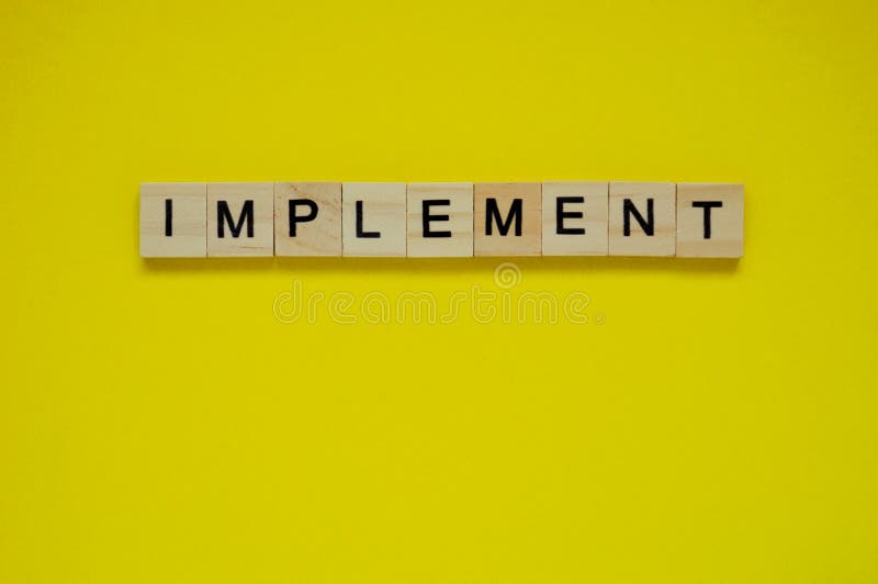 Word Implement. Top View of Wooden Blocks with Letters on Green Surface ...