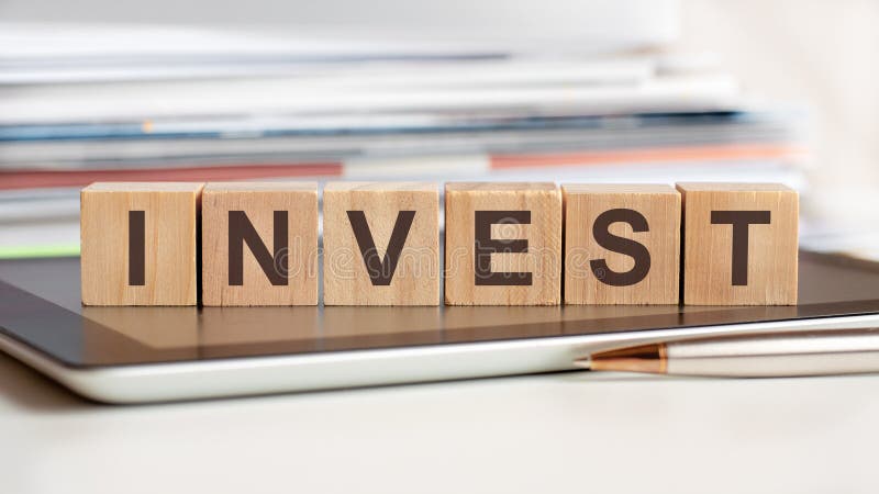 The Word INVEST is Written on Wooden Cubes, Concept Stock Photo - Image ...