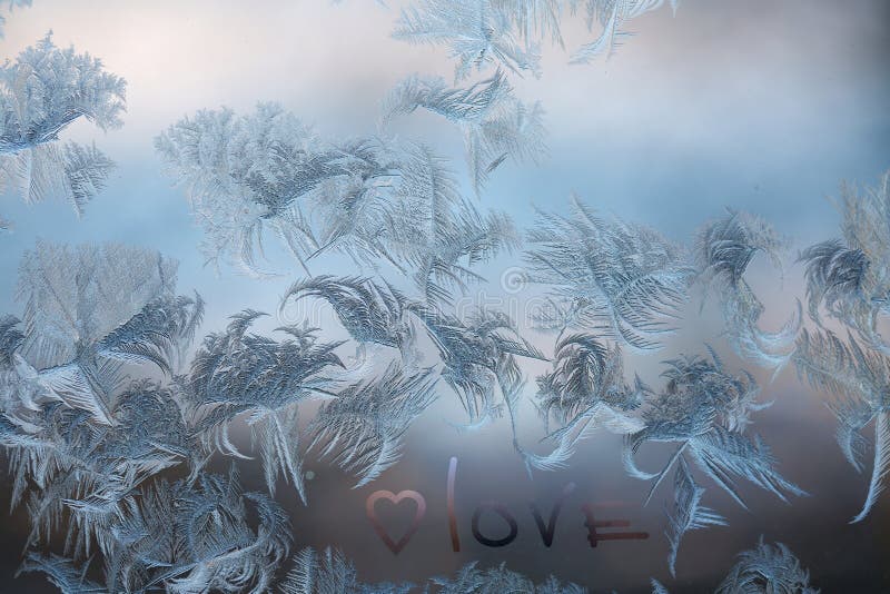Word Love and a Heart on the Glass with Frosty Patterns Stock Image ...