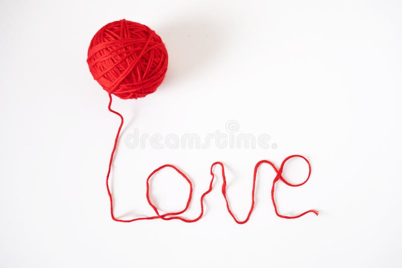 The Word Love is Lined with a Thread from a Ball of Red Color Stock ...