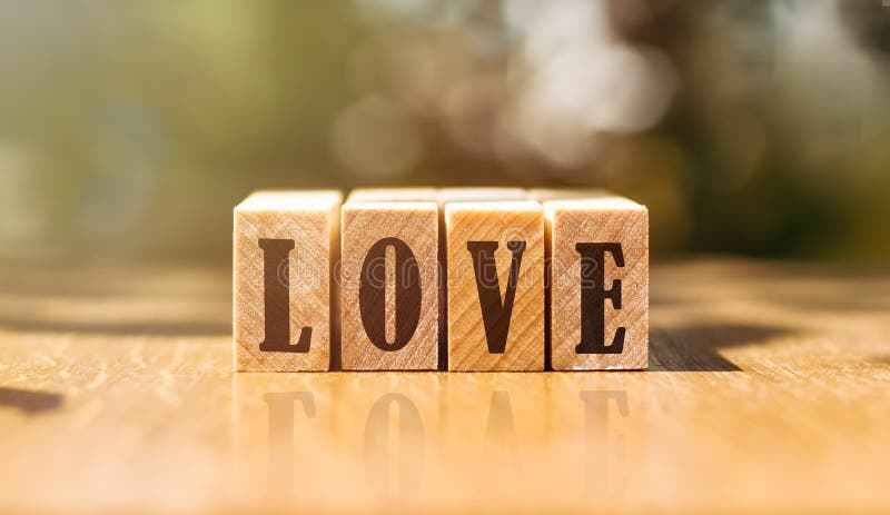 Word LOVE Made with Building Wooden Blocks on Table in Sunlight Stock ...