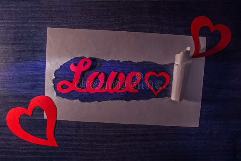 Word love in torn paper stock image. Image of valentines - 138044879