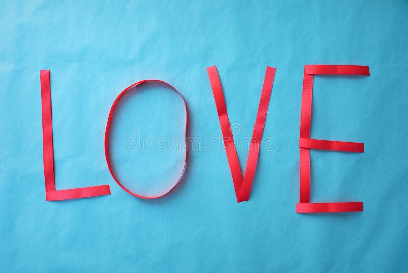 Word Love Written with a Gift Ribbon on a Blue Background Stock Photo ...