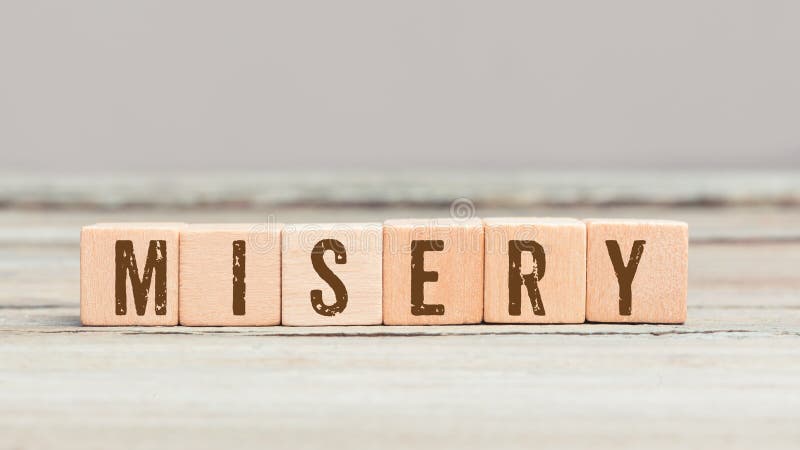 Word Misery on wood cubes stock image. Image of word - 254610719