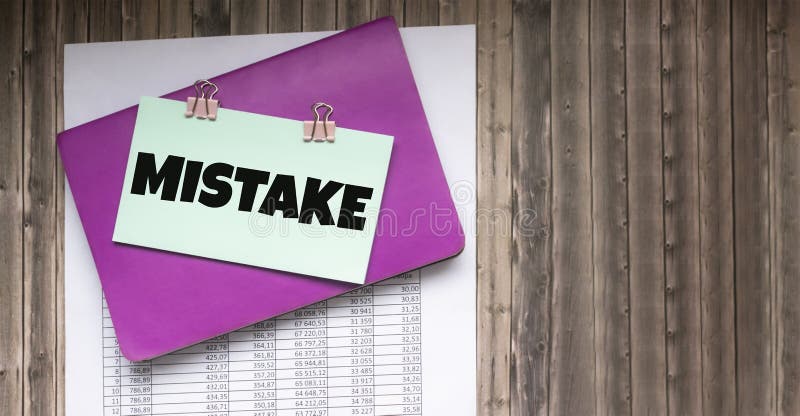 Word MISTAKE, Written on a Sticker that Lies on Documents and a Wooden ...