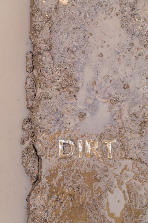 The Word Mud Imprinted in Wet Dirt Road Surface - Close-up with ...