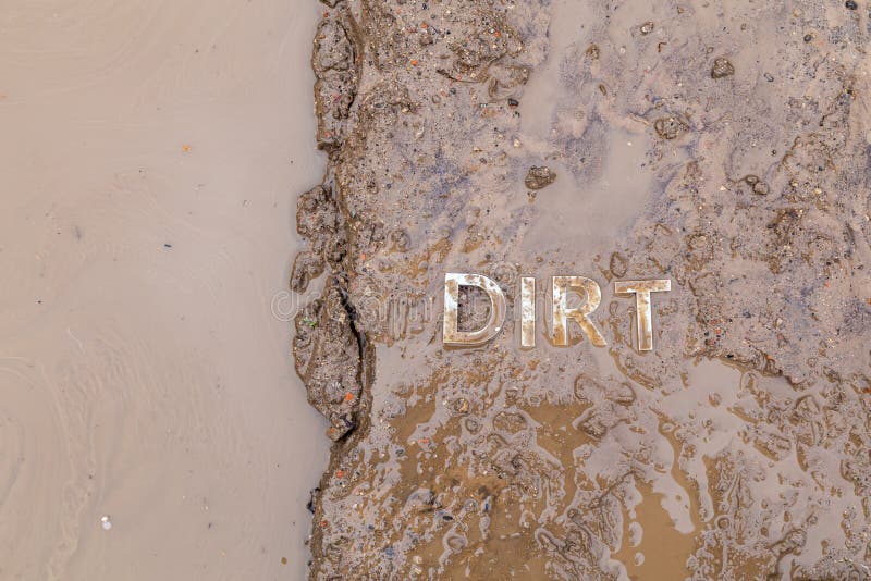 The Word Mud Imprinted in Wet Dirt Road Surface - Close-up with ...
