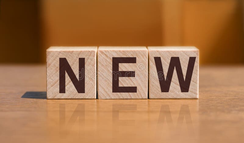 The Word NEW from Wooden Lettering Cubes Stock Photo - Image of ...