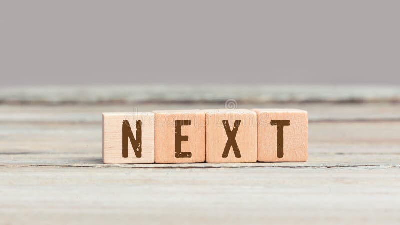 Word Next on wood cubes stock photo. Image of table - 241936452