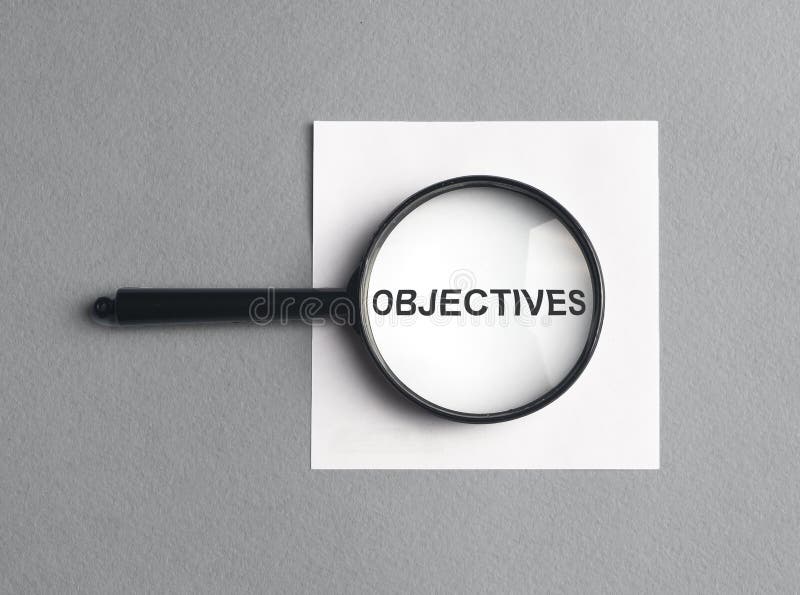Word Objectives through Magnifier on Gray Background. Business Target ...