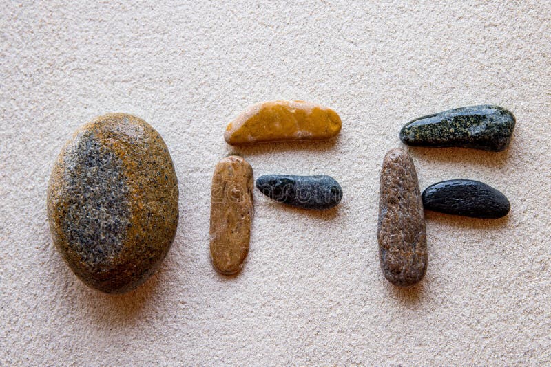 Word "Off" Written Using Colored Stones on White Sand Stock Photo ...