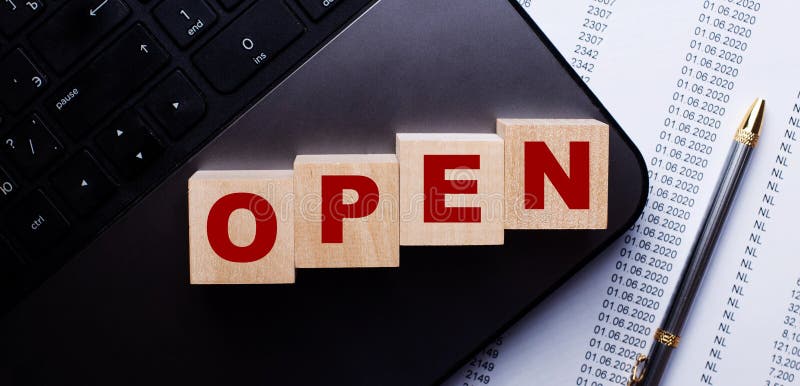 The Word OPEN is Written on Wooden Cubes on the Keyboard Next To the ...