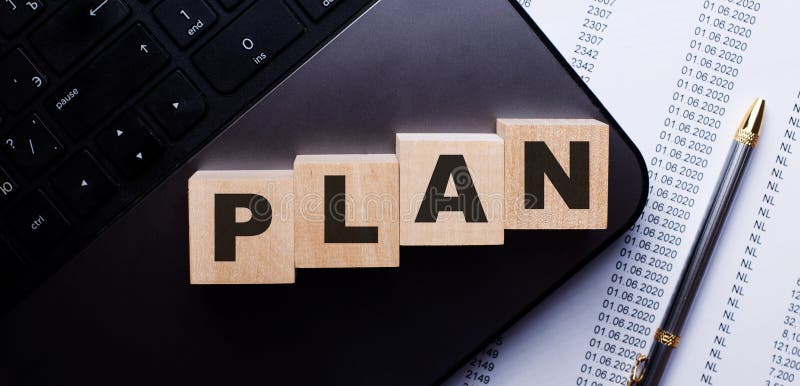 The Word PLAN is Written on Wooden Cubes on the Keyboard Next To the ...