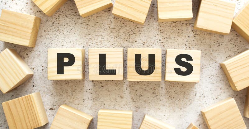 The Word PLUS Consists of Wooden Cubes with Letters, Top View on a ...