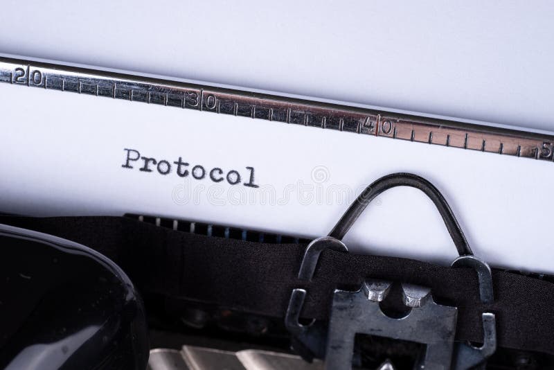 The Protocol is Written on a Red Folder for Papers on the Office Desk ...