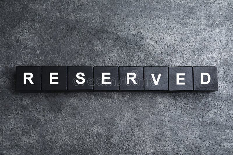 Word RESERVED Made with Cubes on Grey Surface, Top View. Table Setting ...