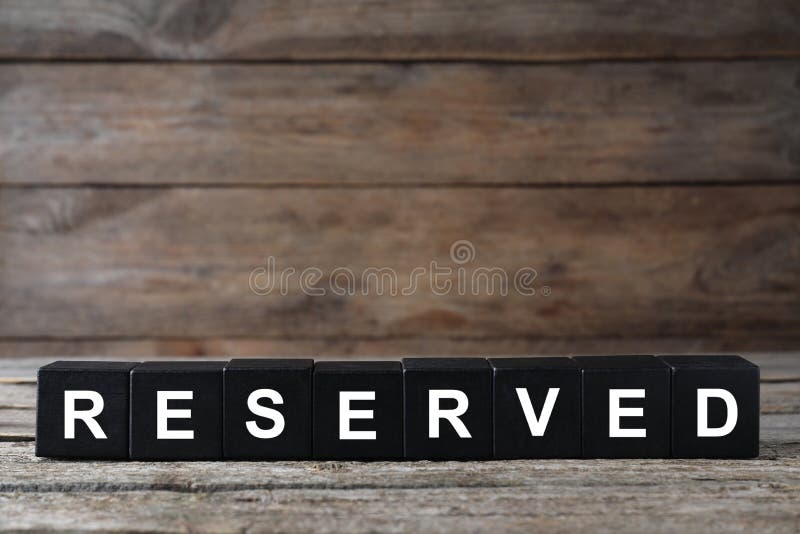 Word RESERVED Made with Cubes on Wooden Surface. Table Setting Element ...