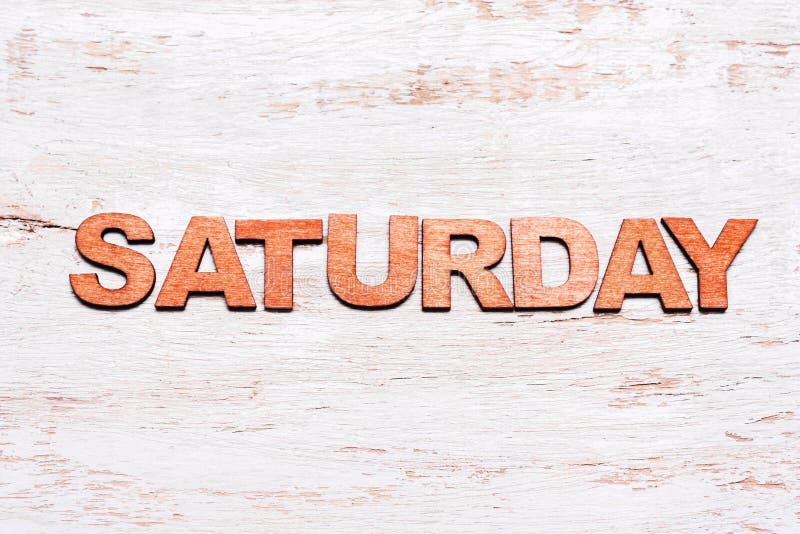 Word `saturday` of Colored Plastic Magnetic Letters on Blue Paper ...