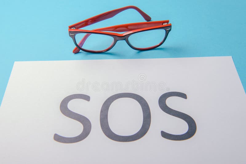 Word SOS written on paper stock photo. Image of mark - 165160158